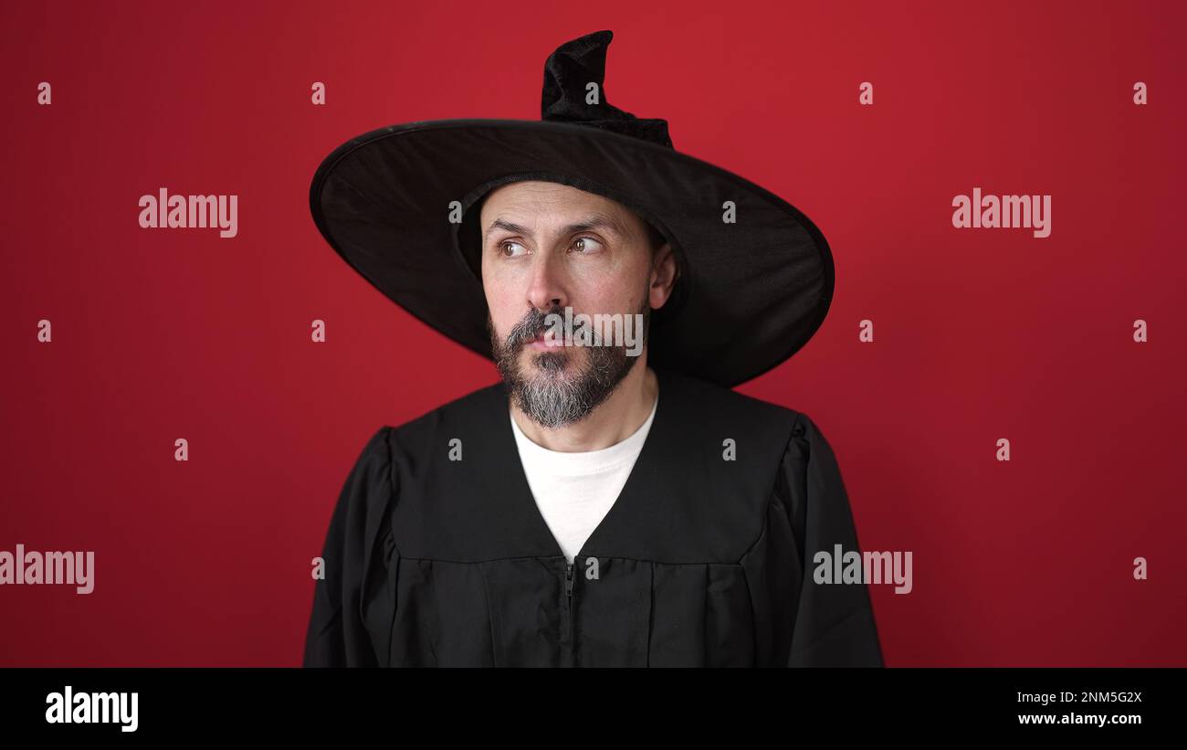 Young bald man wearing wizard costume standing with fear expression ...