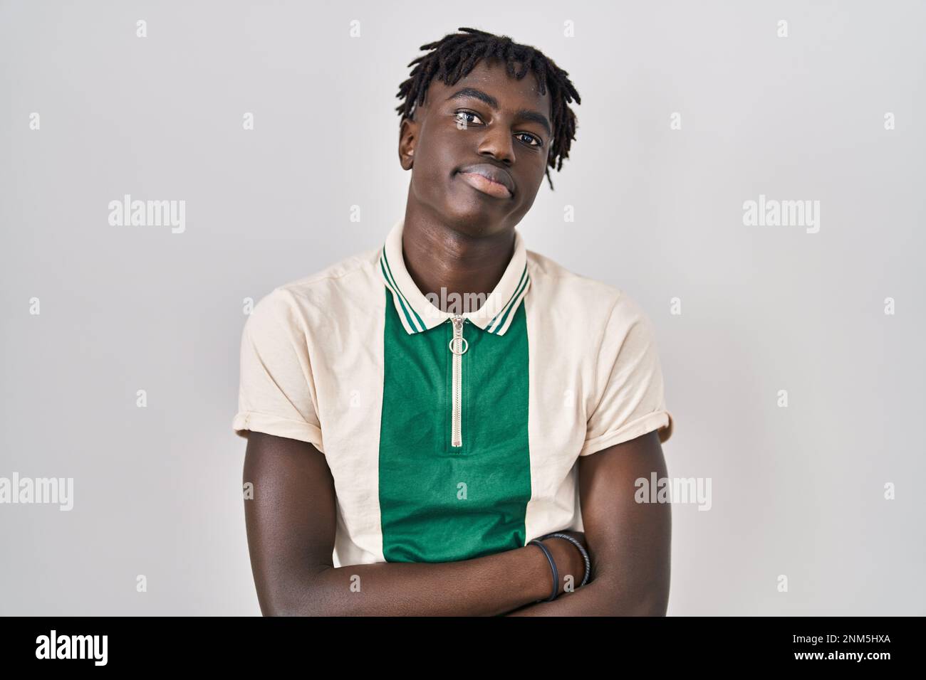 African man with dreadlocks standing over isolated background depressed ...
