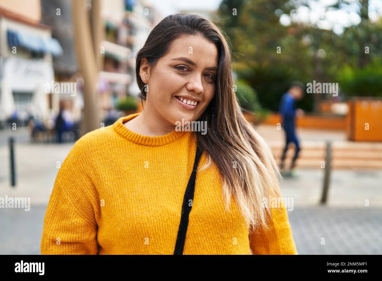 Young beautiful plus size woman smiling confident standing at street ...