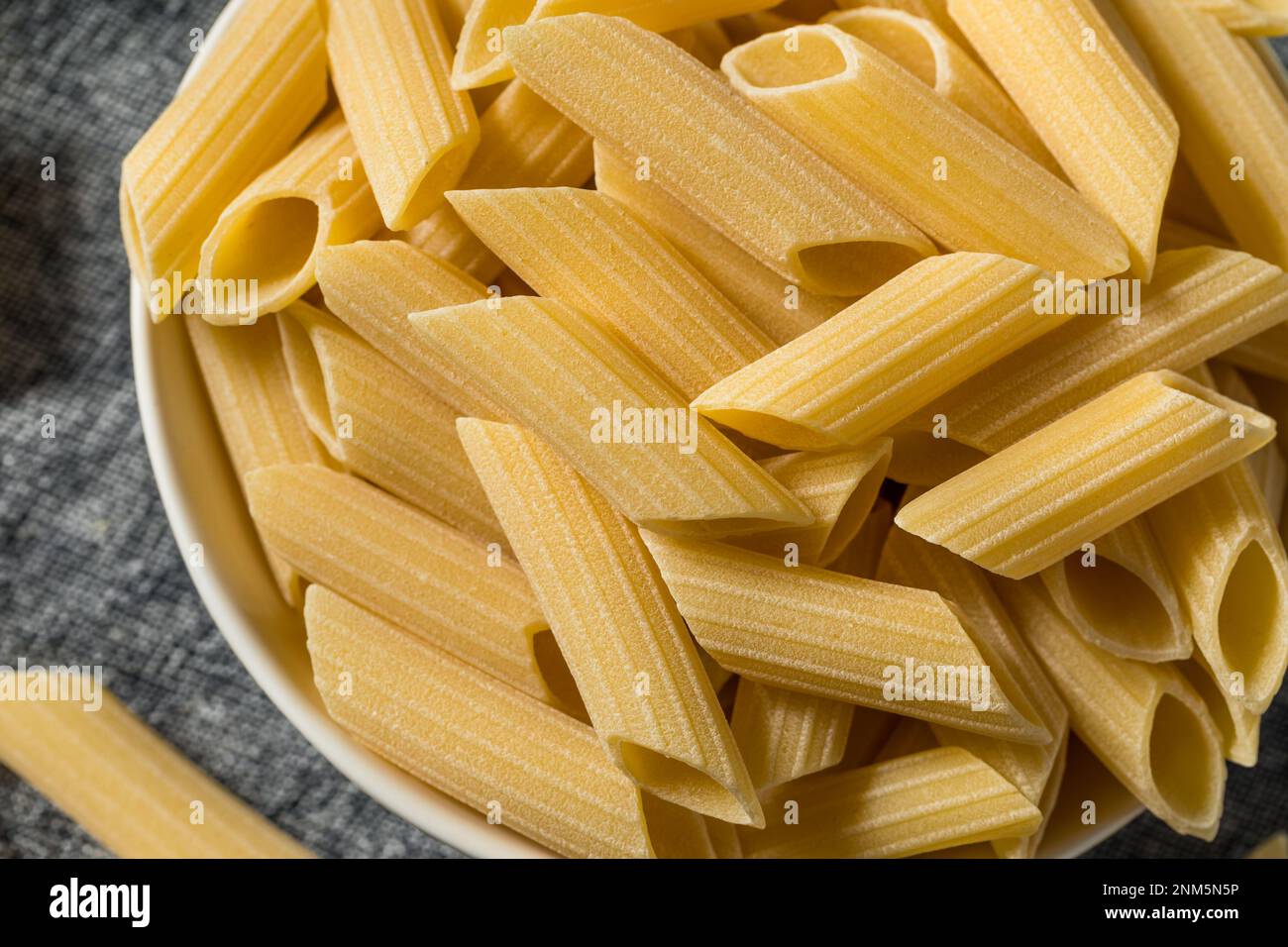 Raw Organic Pennoni Pasta in a Bowl Stock Photo - Alamy