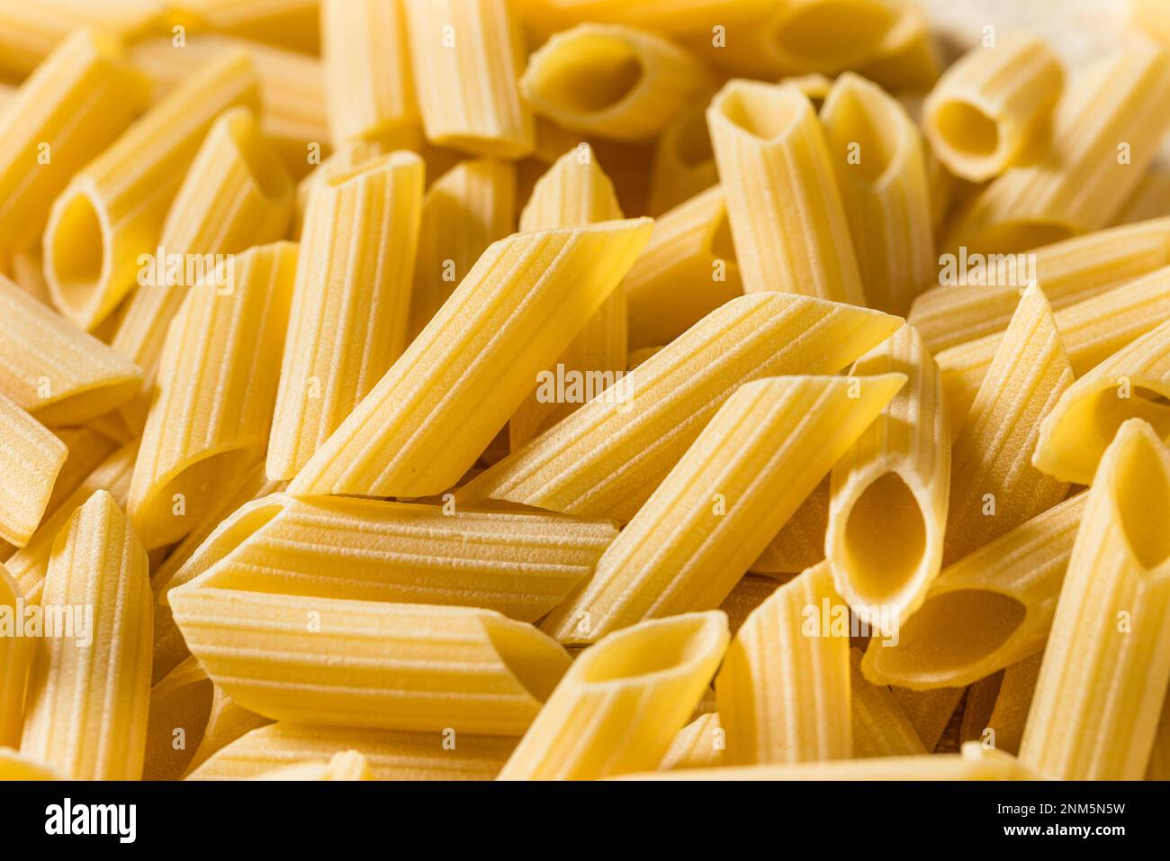Raw Organic Pennoni Pasta in a Bowl Stock Photo - Alamy