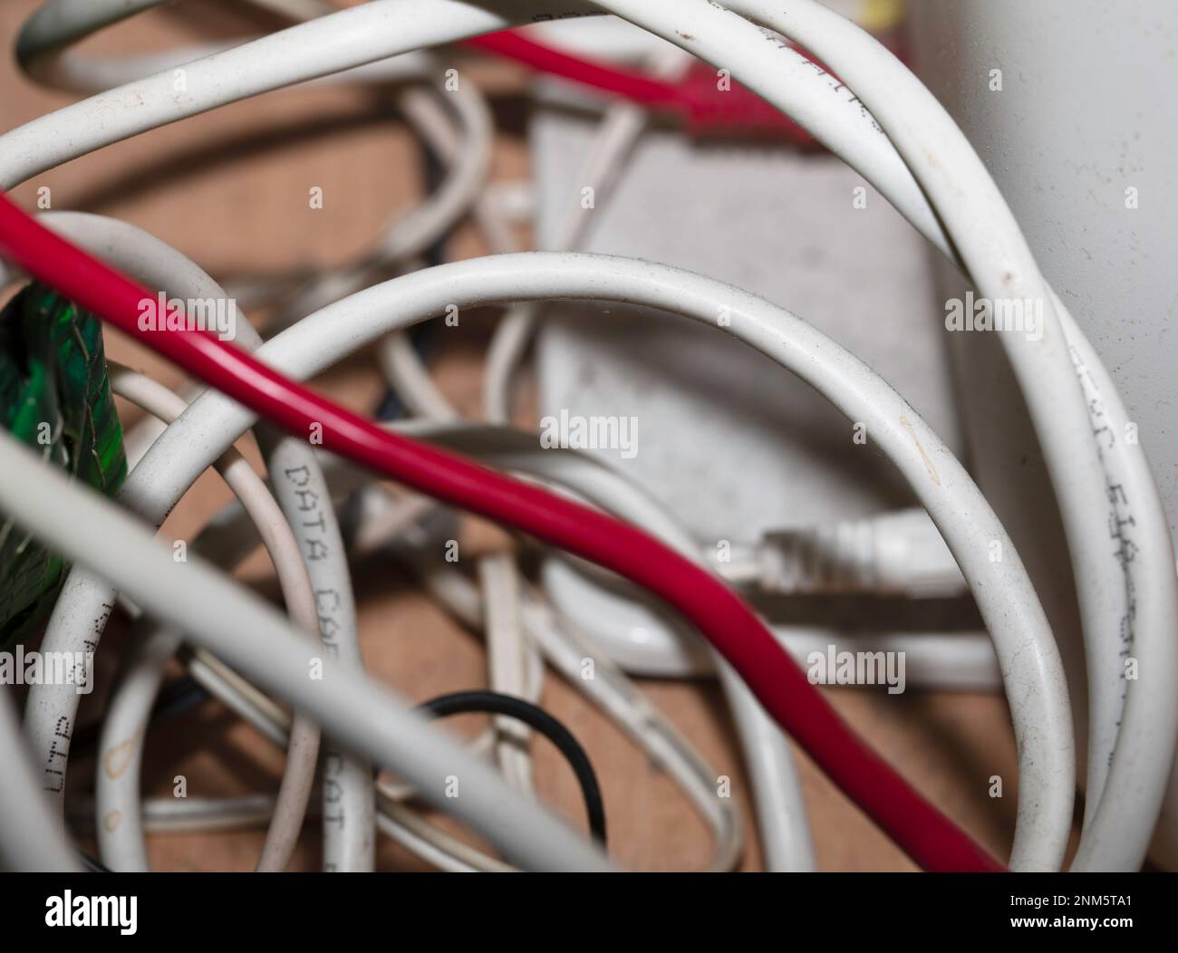 Cable clutter at the router, messy installation Stock Photo - Alamy