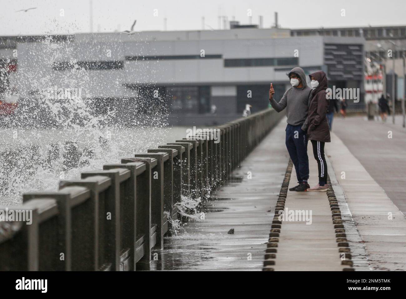 San Francisco resident Gokul Ramesh left, takes a video of breaking ...