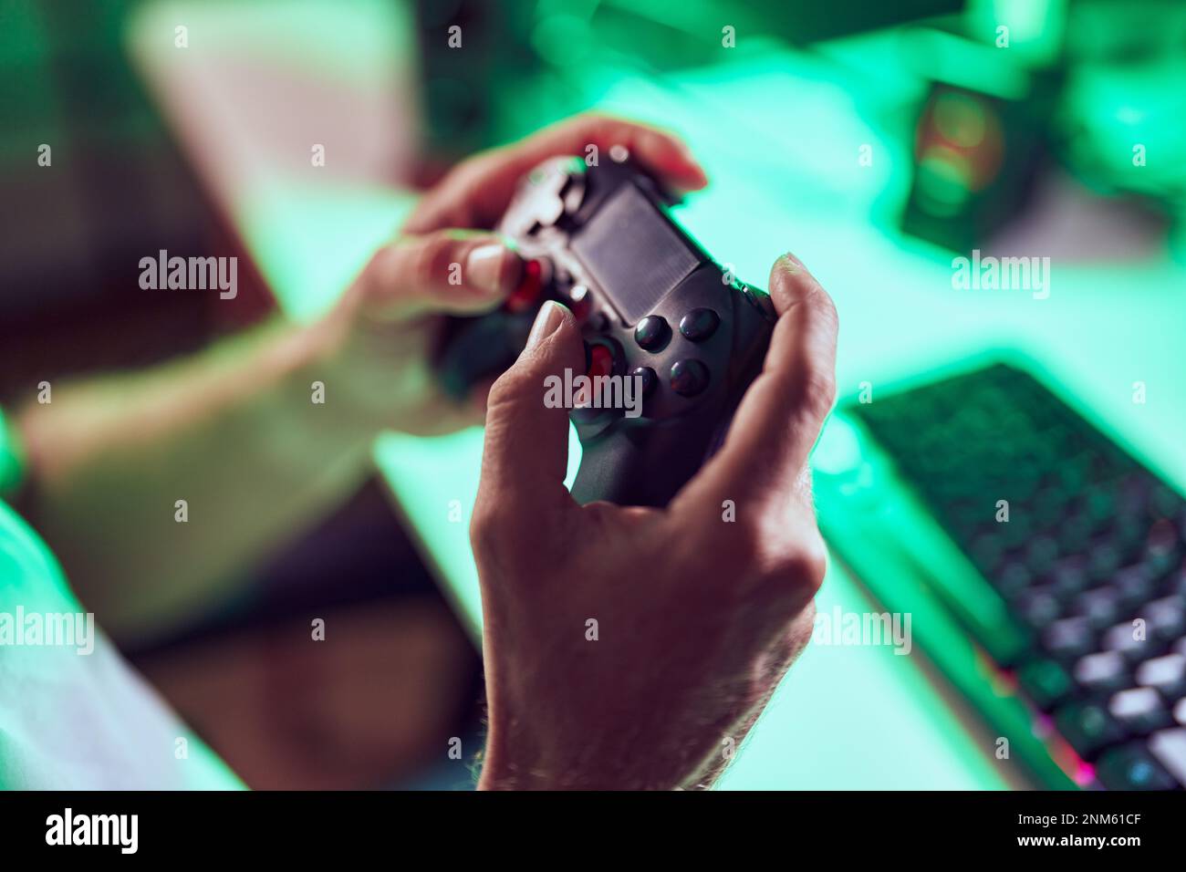 Young blond man streamer playing video game using joystick at gaming ...