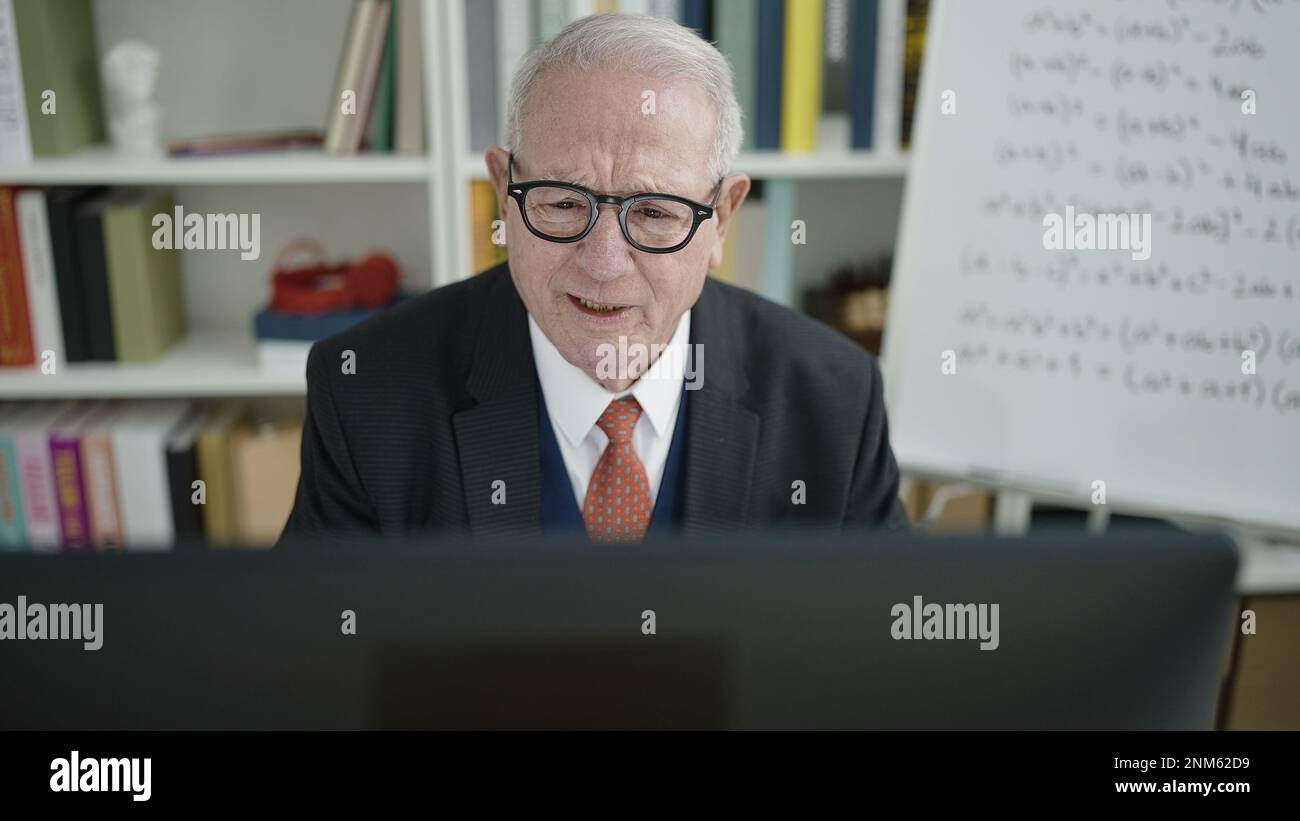 senior university teacher using computer at university classroom Stock ...