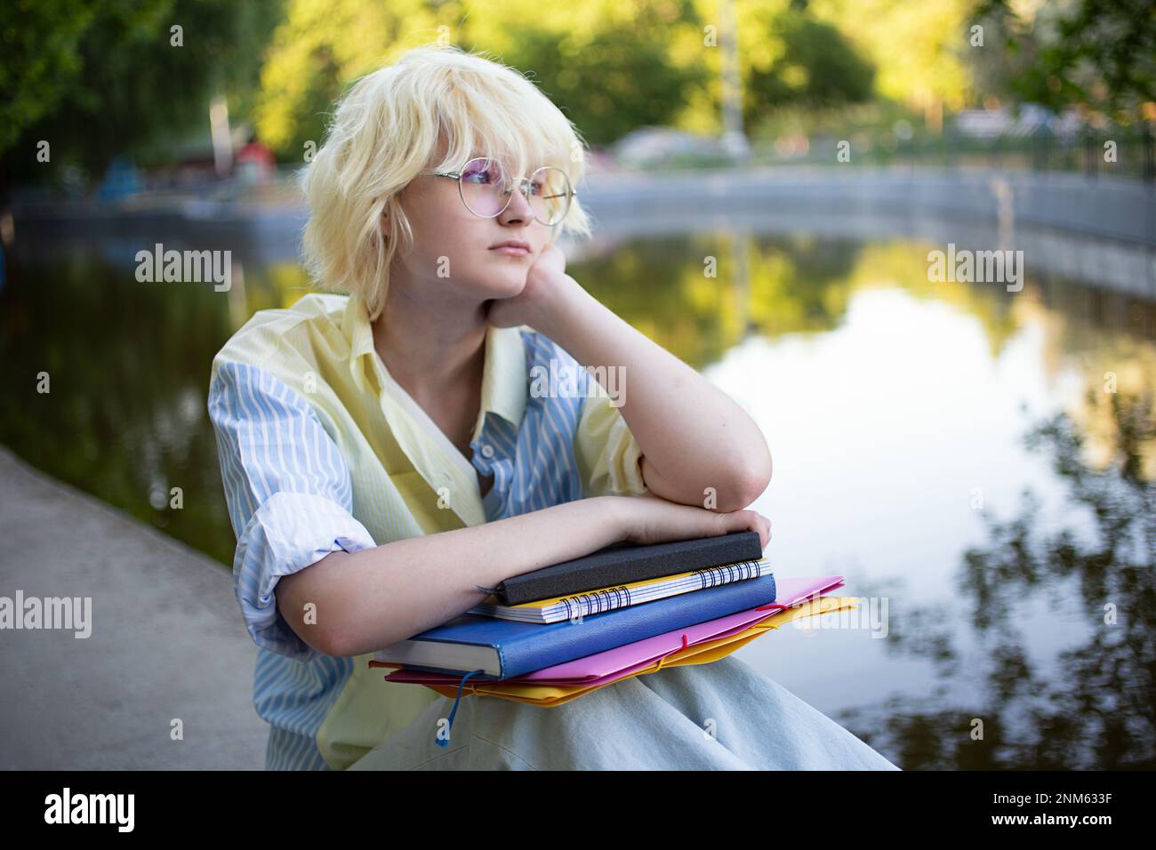 Photography with teenage girl with books and students folders,deep in ...