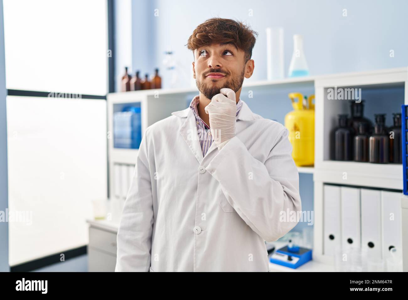 Arab man with beard working at scientist laboratory thinking concentrated about doubt with ...