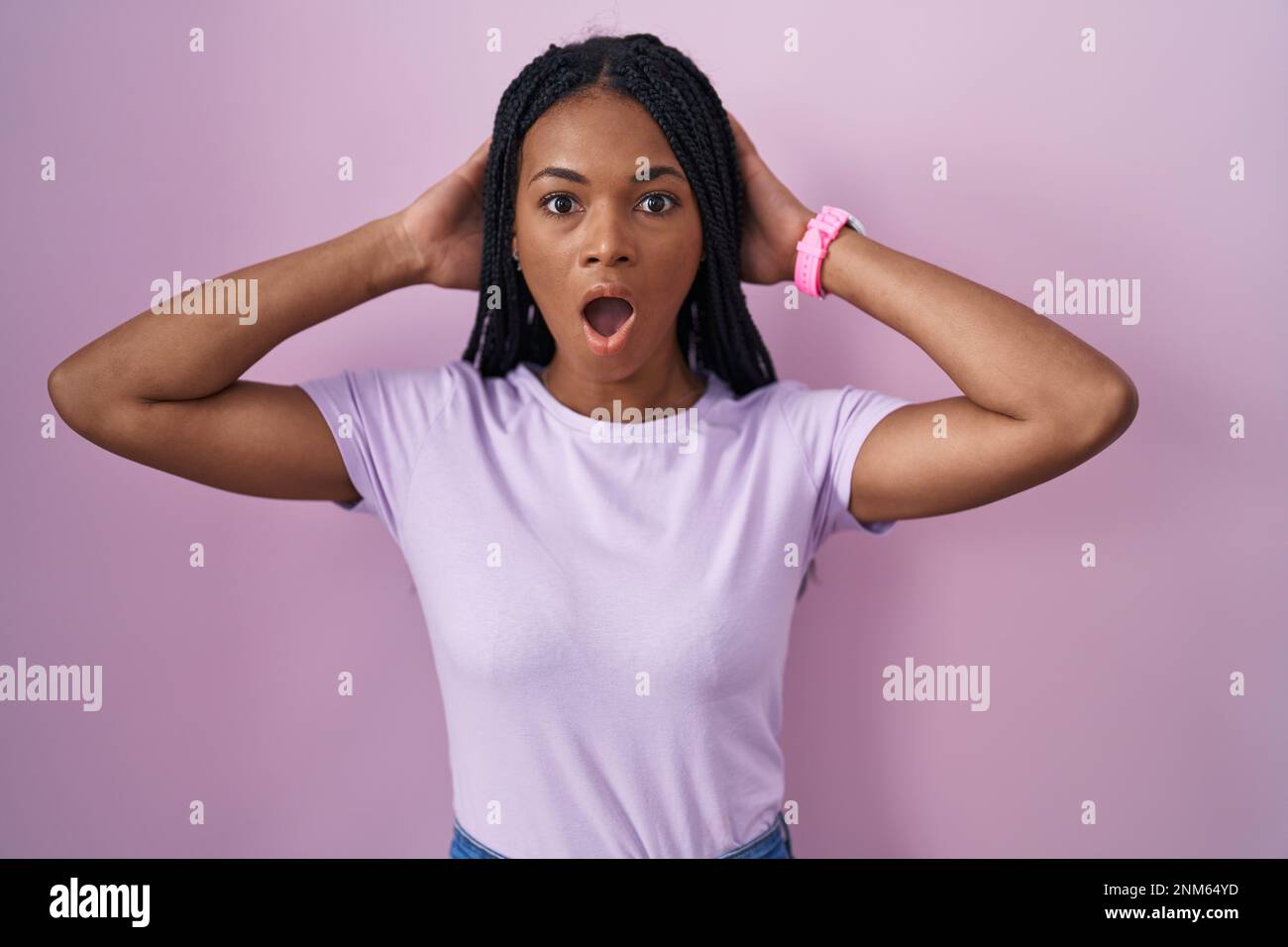 African american woman with braids standing over pink background crazy ...