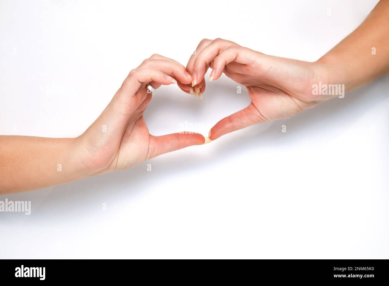Woman female hand making a heart gesture with her fingers on white ...