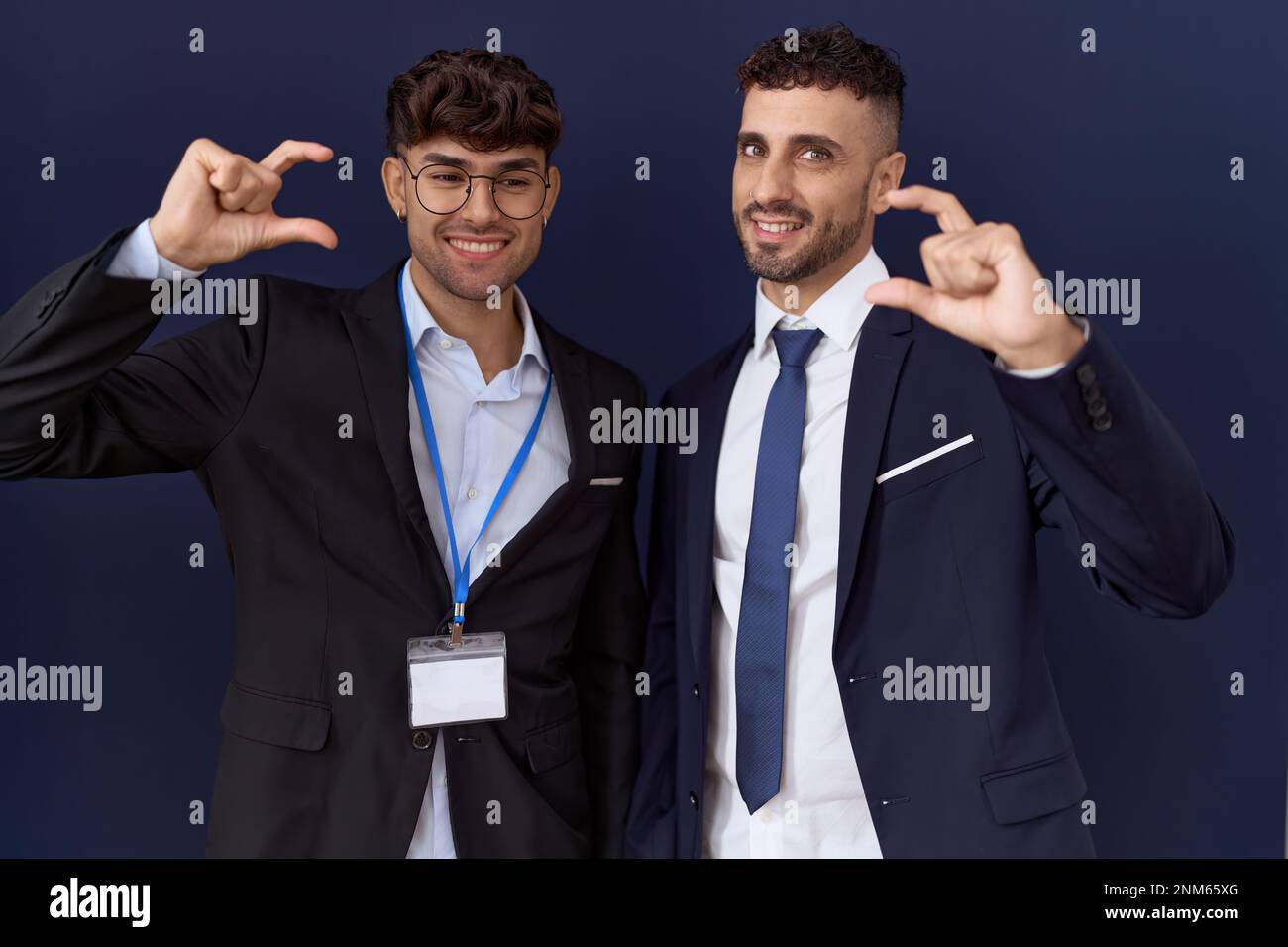 Two hispanic business men wearing business clothes smiling and ...