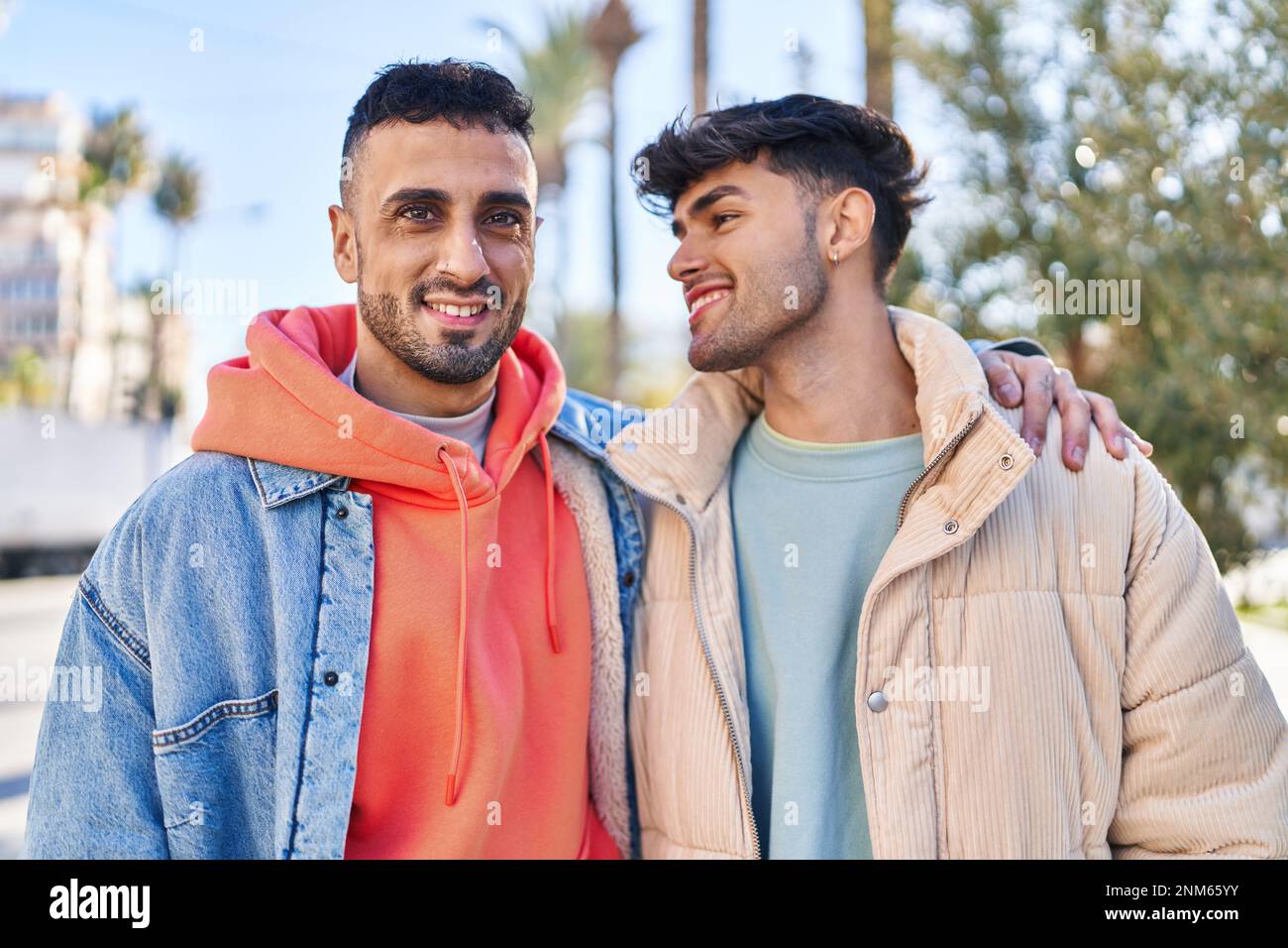 Two man couple hugging each other standing at street Stock Photo - Alamy