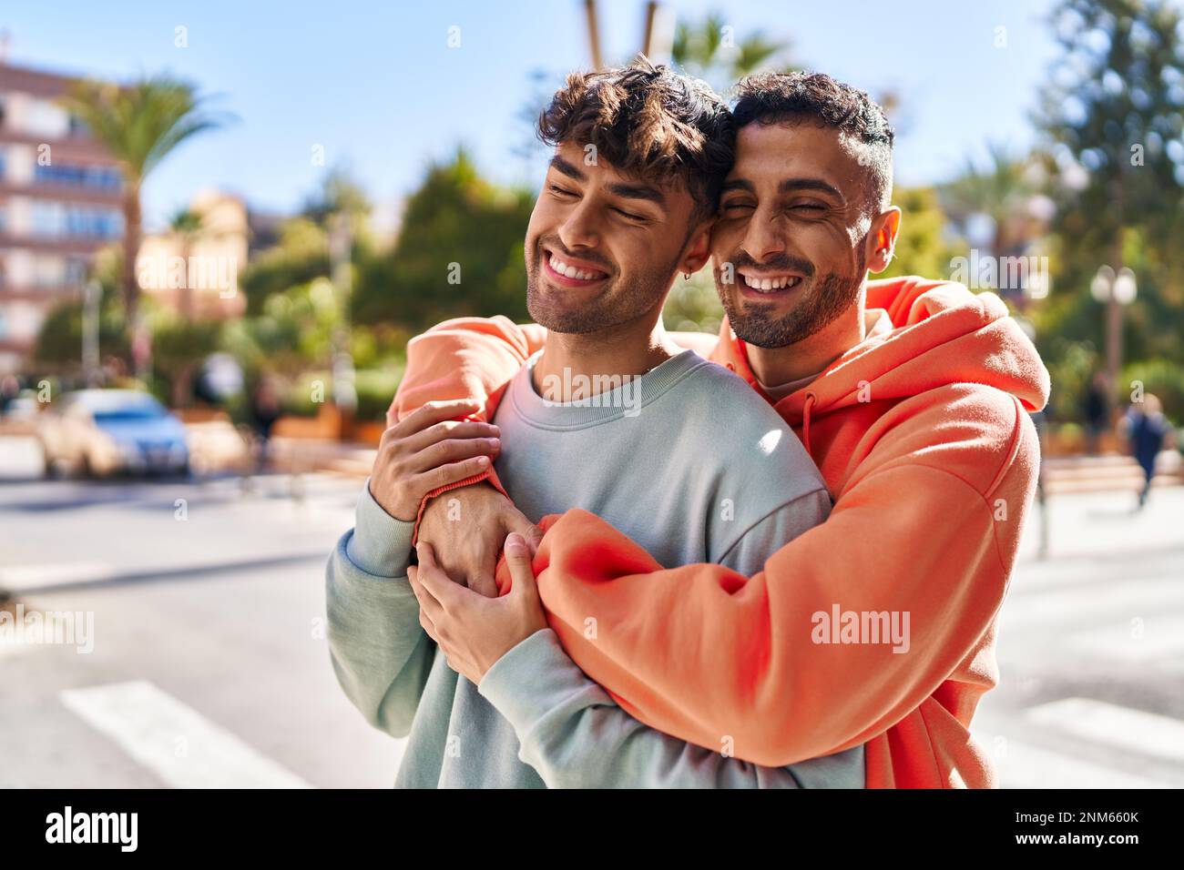 Two man couple hugging each other standing at street Stock Photo - Alamy