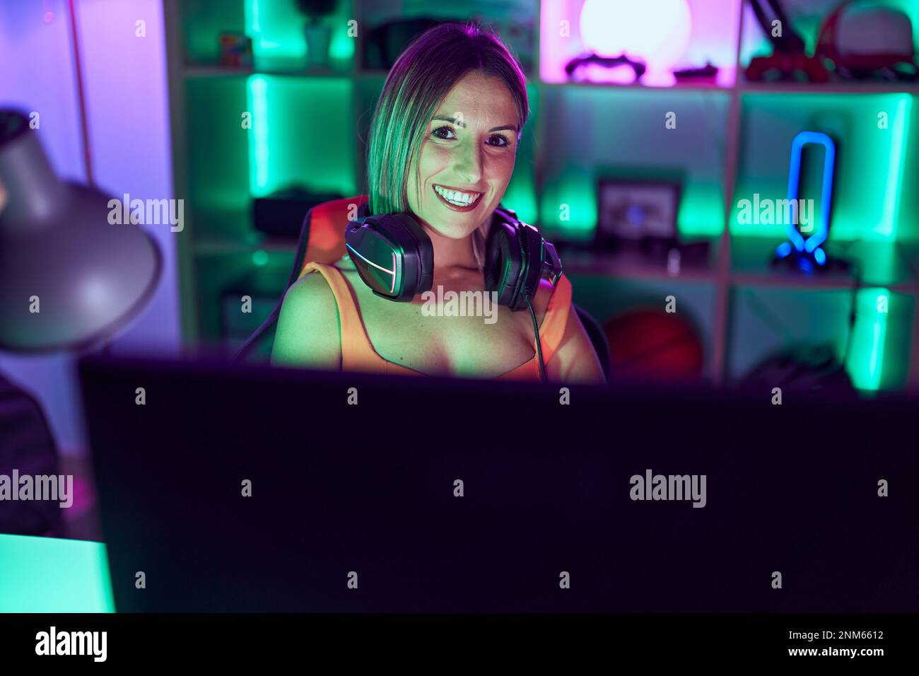 Young beautiful hispanic woman streamer playing video game using ...