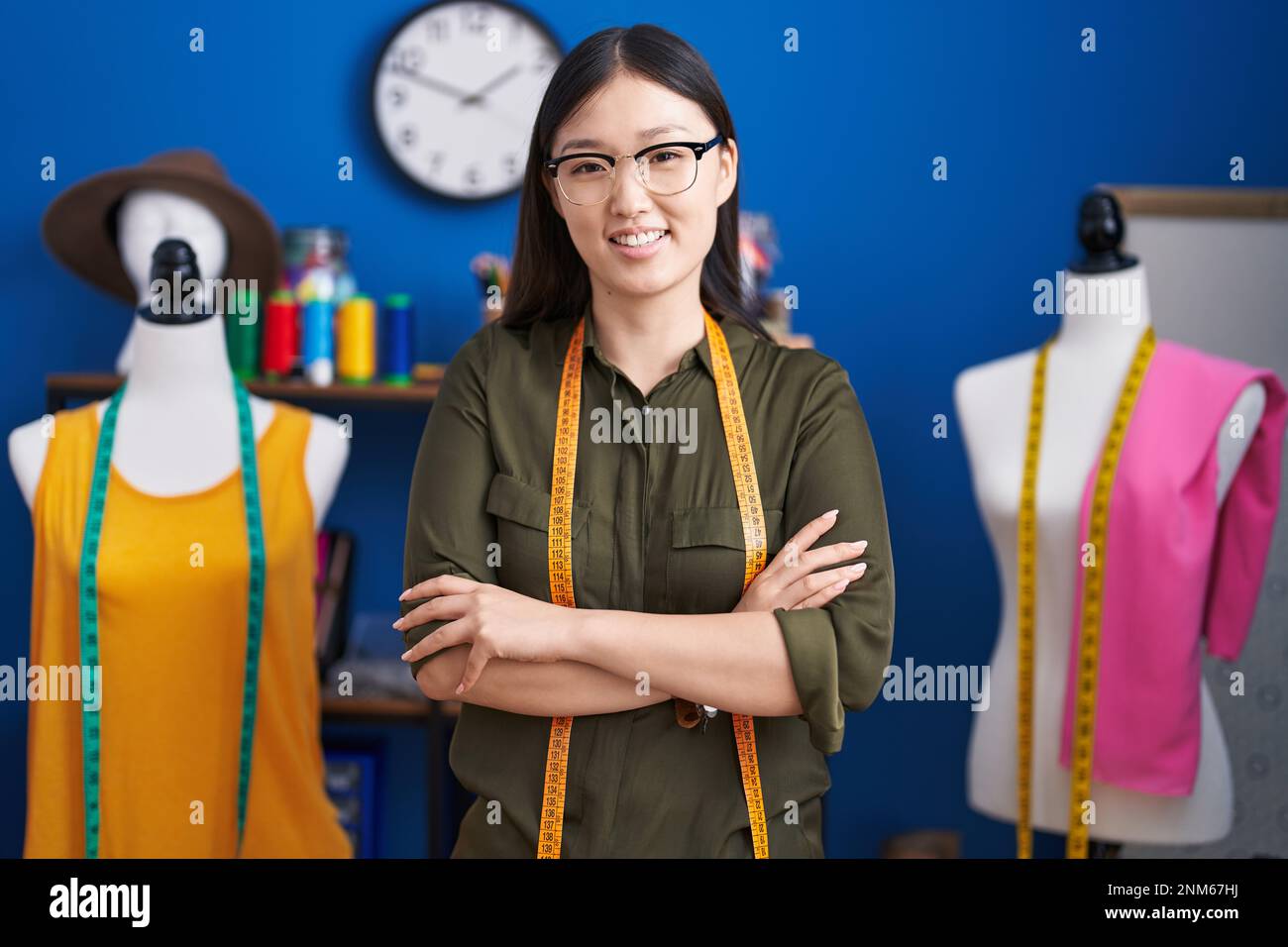Chinese woman tailor smiling confident standing with arms crossed ...