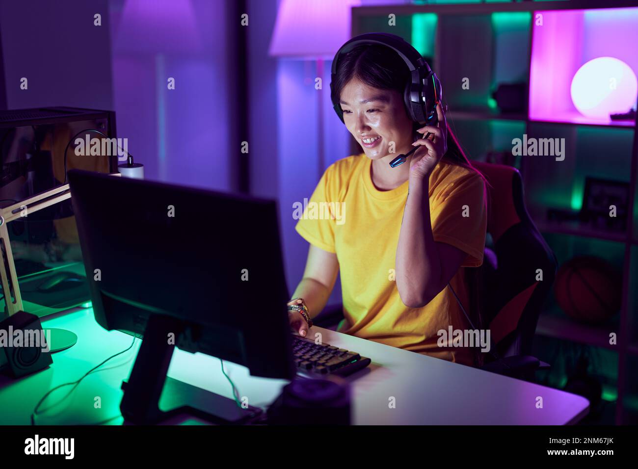 Chinese woman streamer smiling confident using computer at gaming room ...