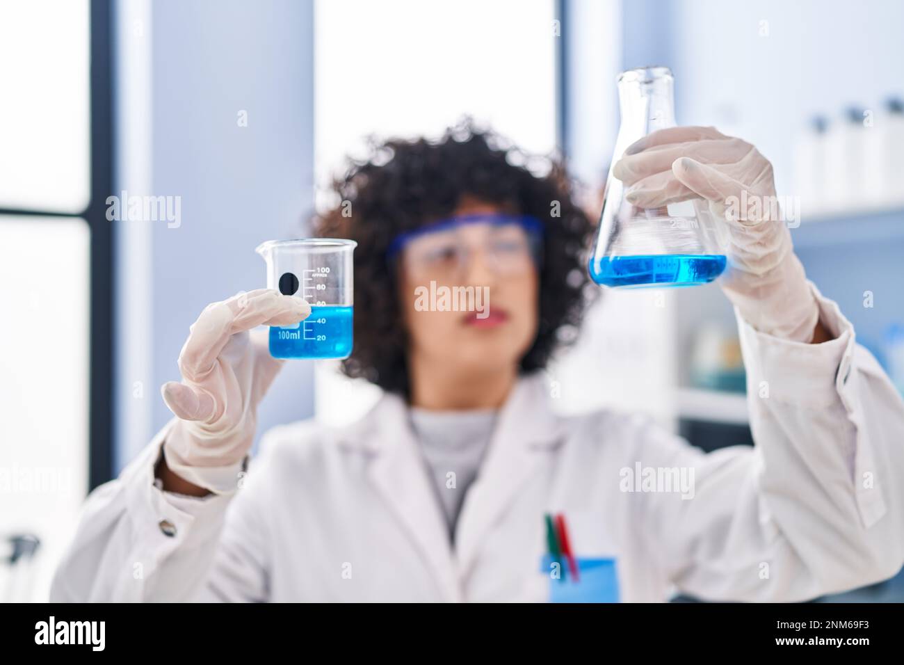 Young middle east woman scientist measuring liquid at laboratory Stock ...