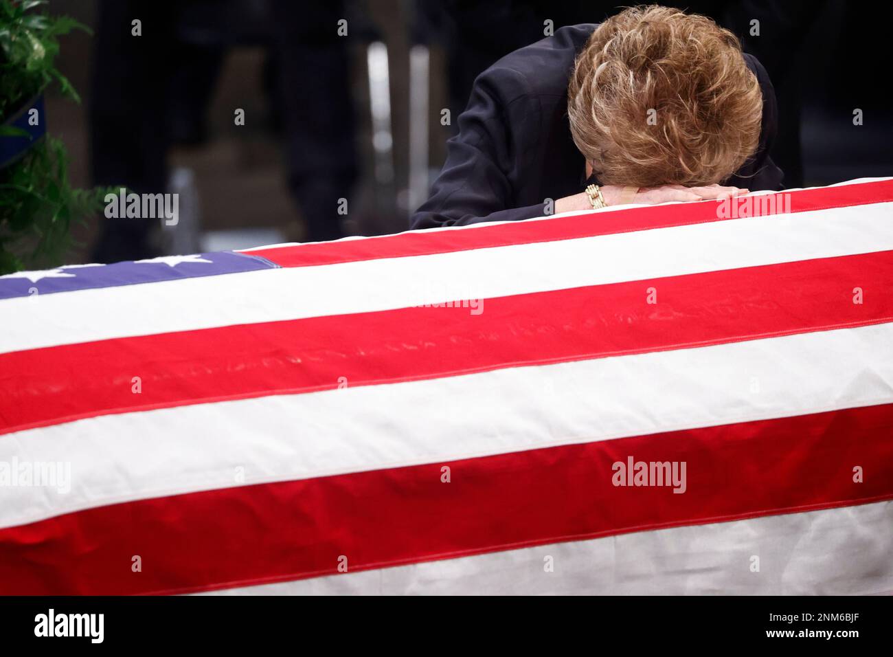 Elizabeth Dole cries on the casket of her husband, former Sen. Bob Dole ...