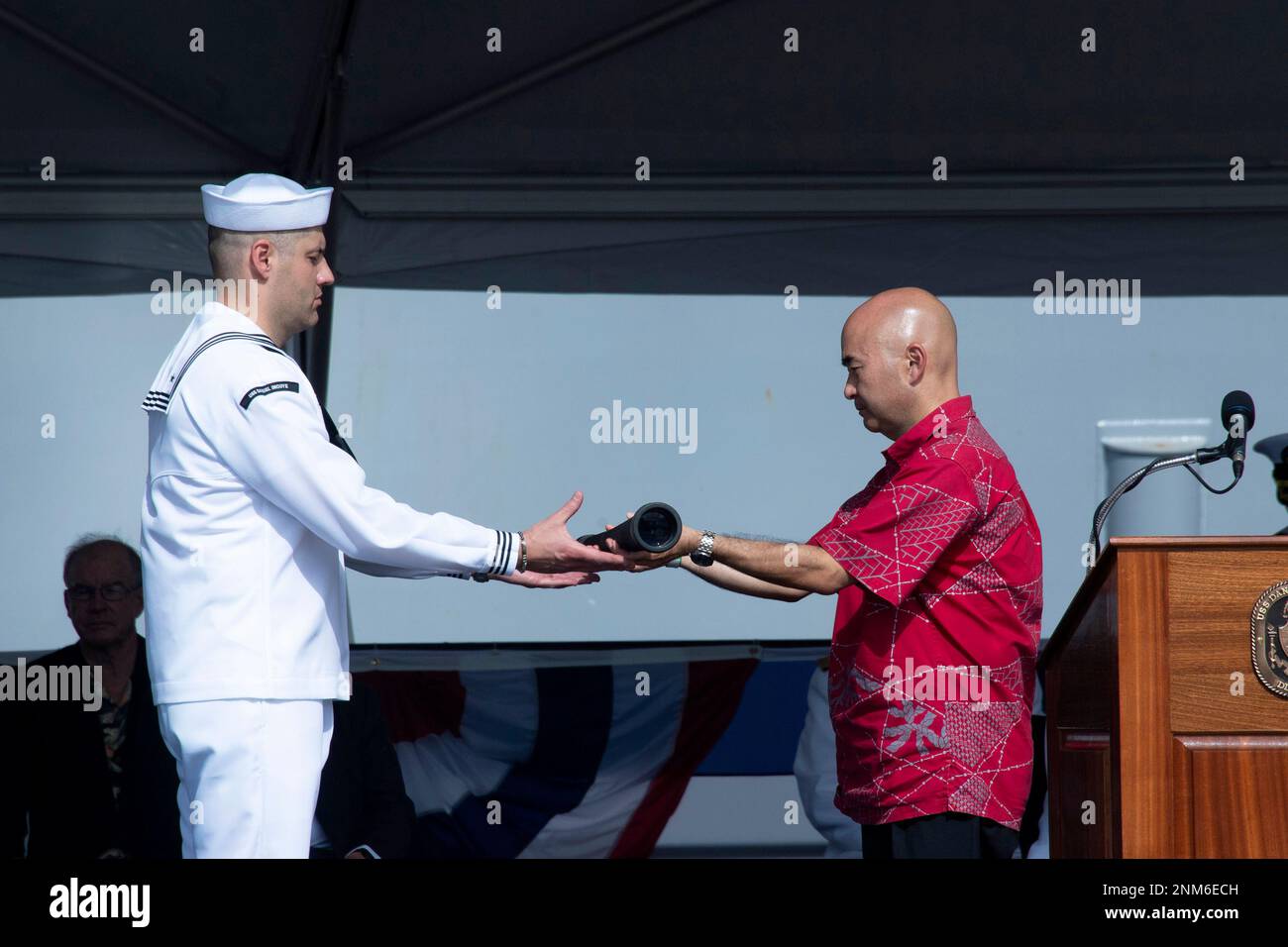 Ken Inouye, son of Daniel Inouye, right, passes the Long Glass to Petty ...