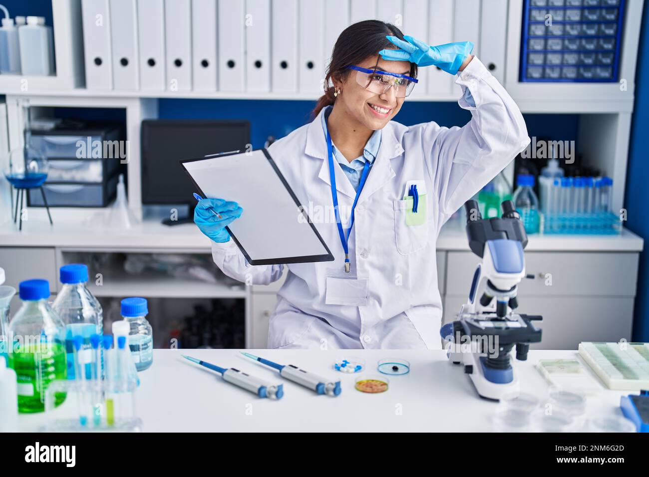 Hispanic young woman working at scientist laboratory very happy and ...