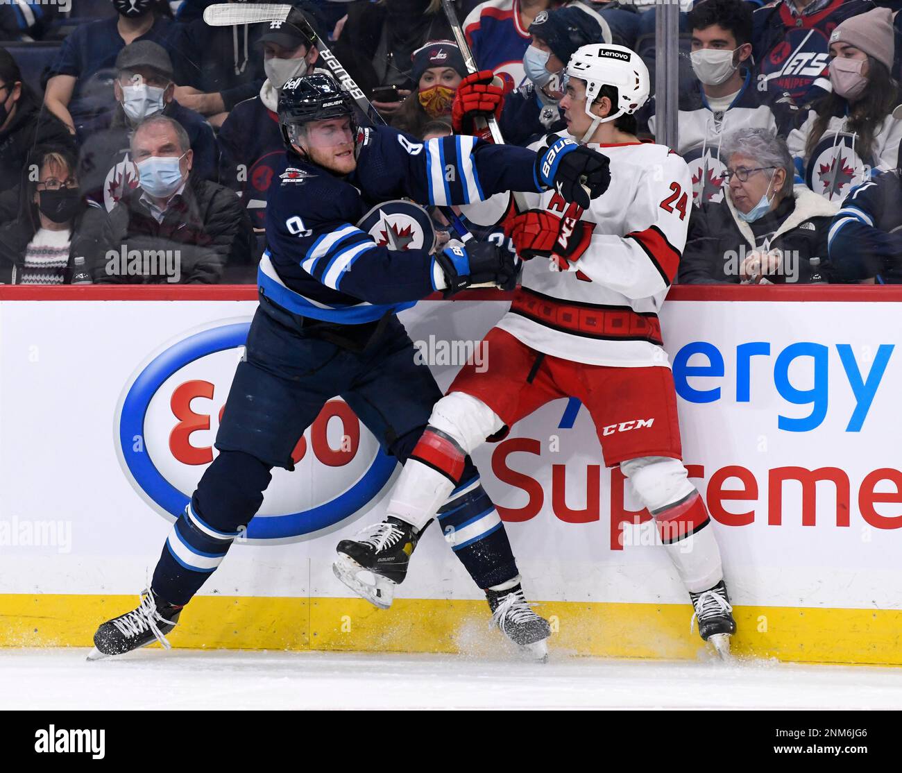 Winnipeg Jets' Andrew Copp (9) checks Carolina Hurricanes' Seth Jarvis ...