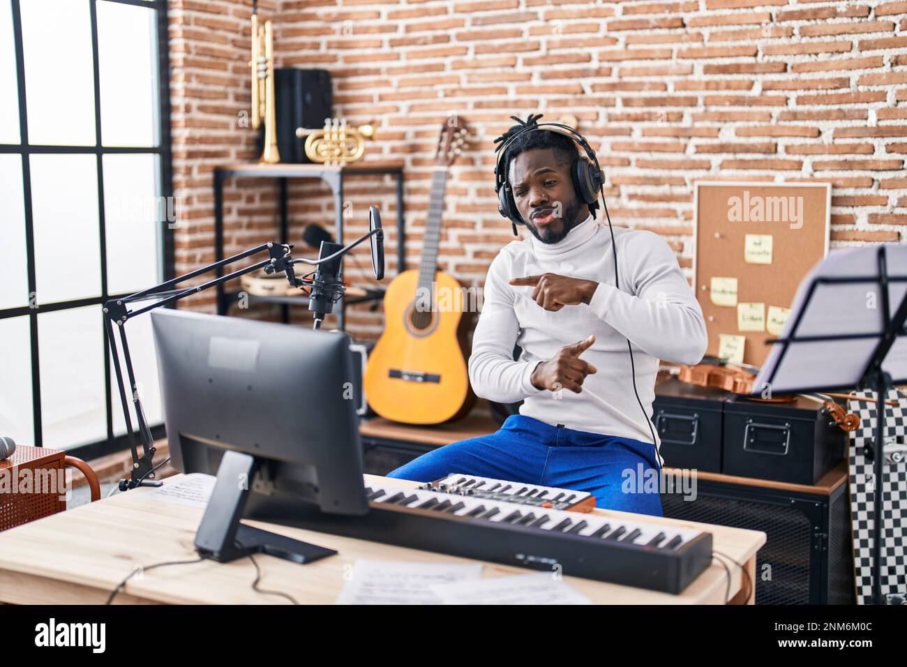 African american woman musician playing piano keyboard and dancing at ...