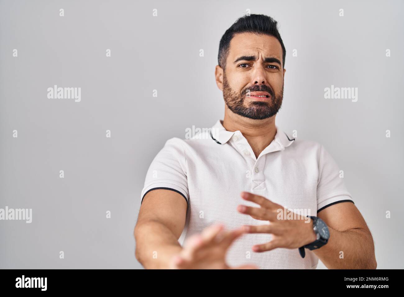 Young hispanic man with beard wearing casual clothes over white ...