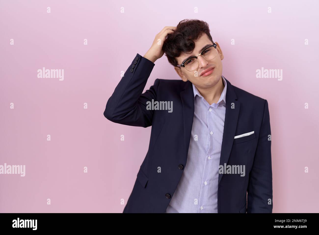 Young non binary man with beard wearing suit and tie confuse and wonder ...