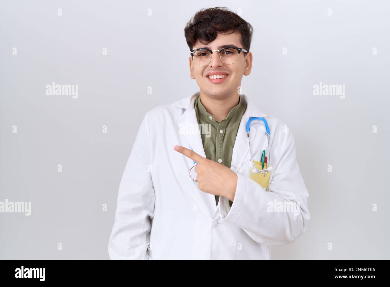 Young non binary man wearing doctor uniform and stethoscope cheerful ...