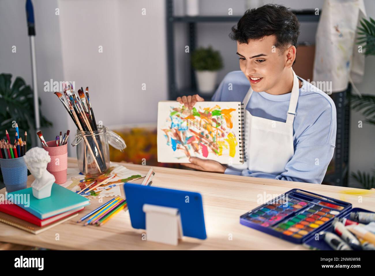 Young non binary man artist having online drawing class at art studio ...