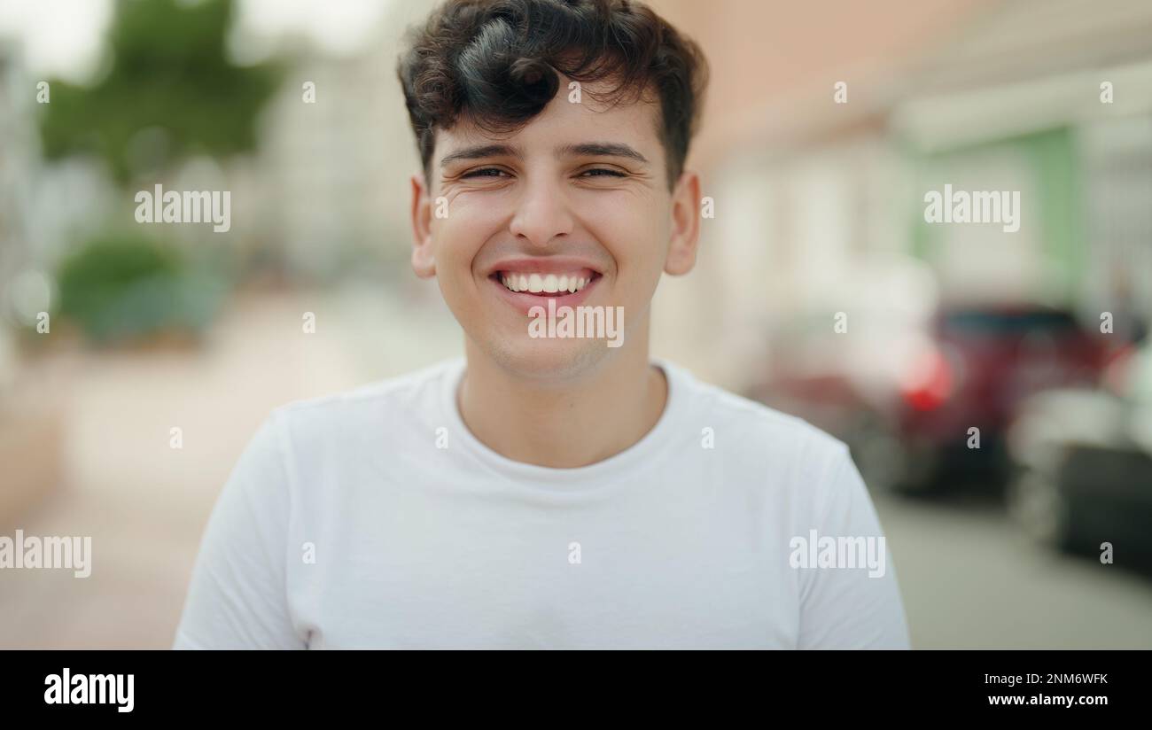 Non binary man smiling confident standing at street Stock Photo - Alamy