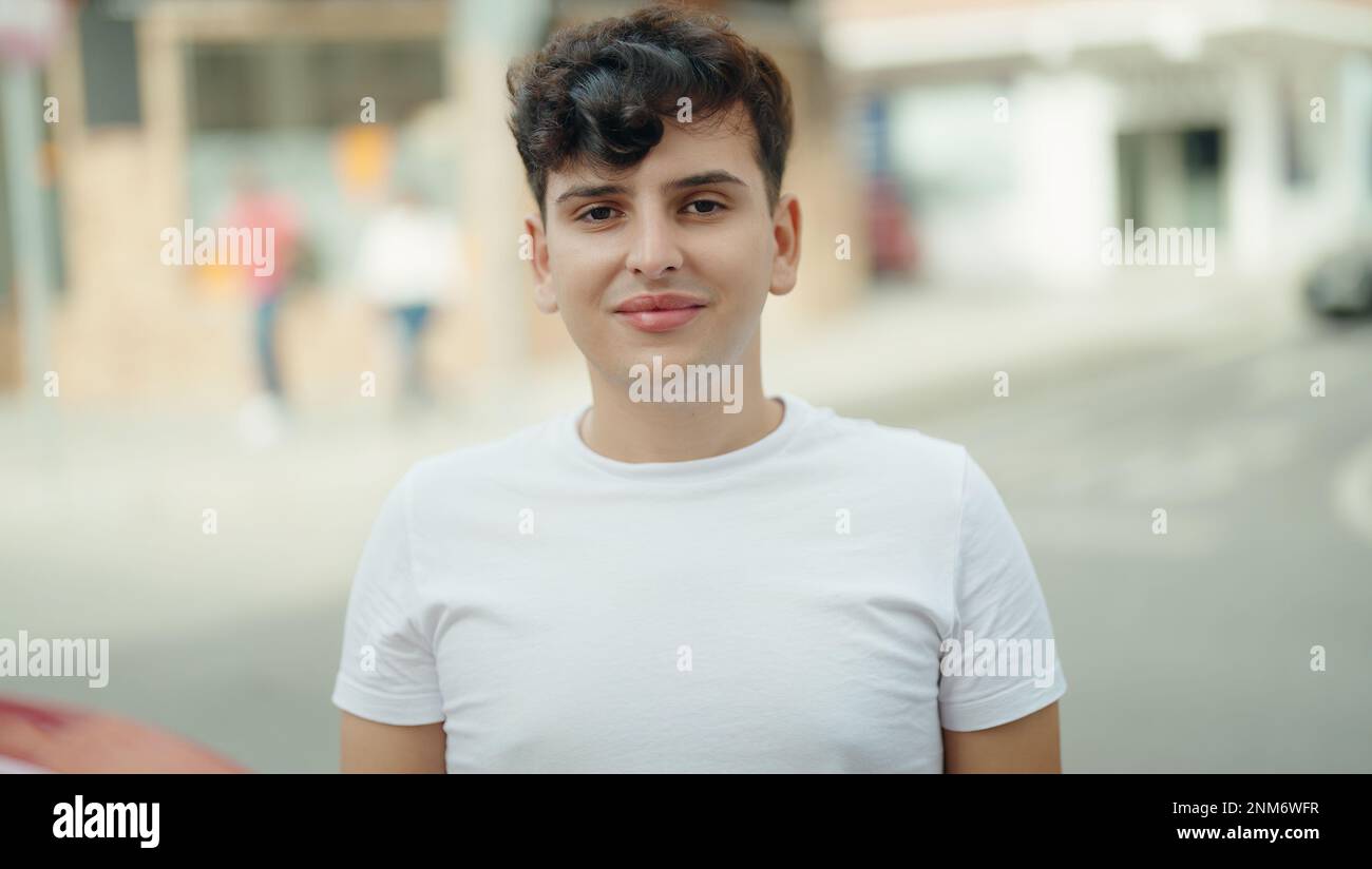 Non binary man smiling confident standing at street Stock Photo - Alamy