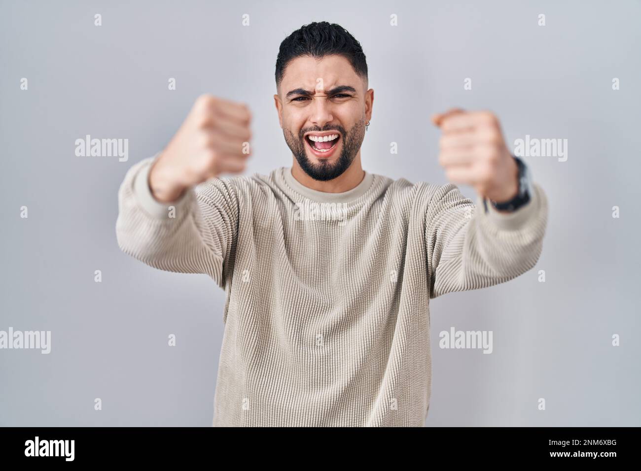 Young handsome man standing over isolated background angry and mad ...