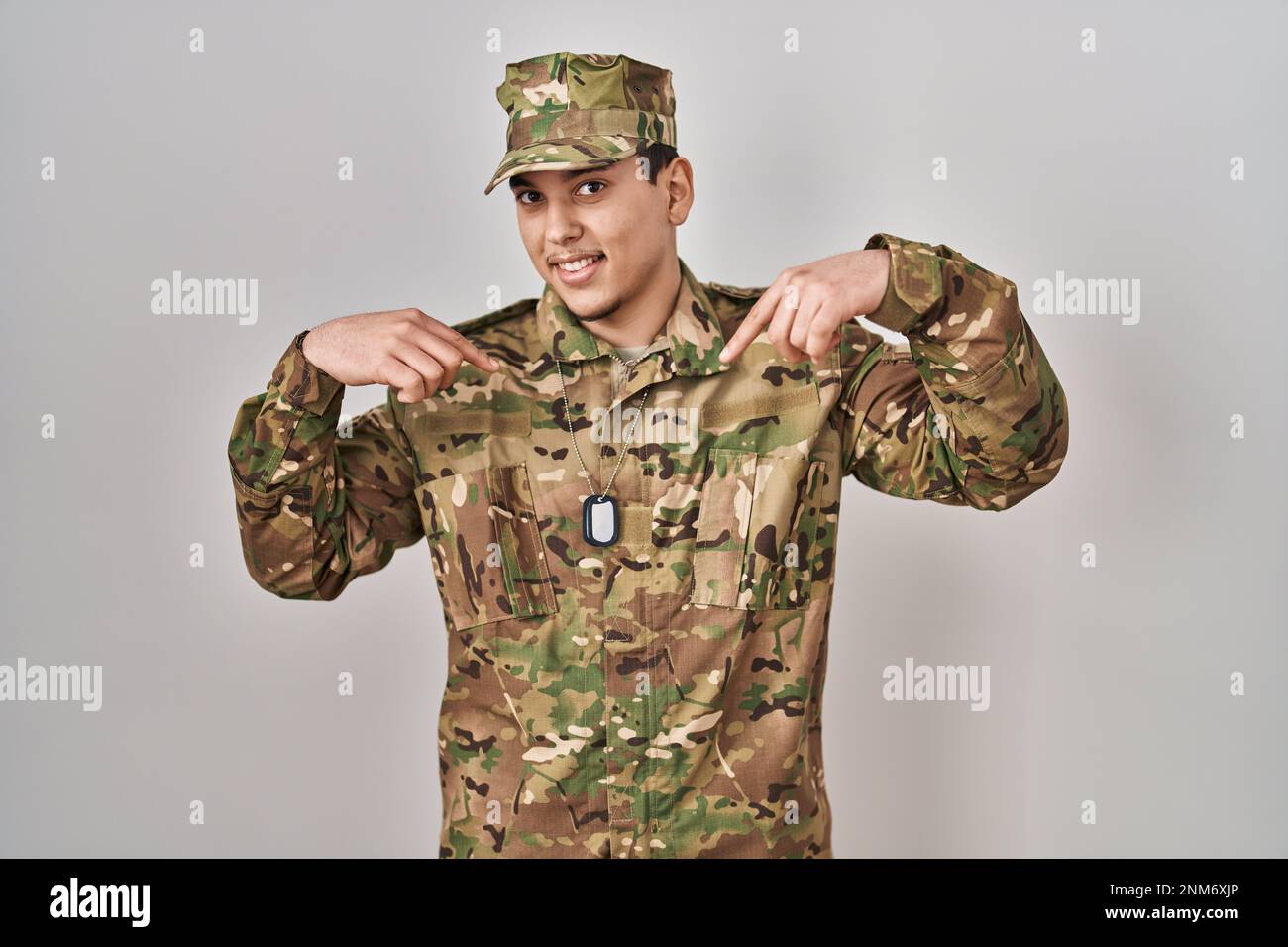Young arab man wearing camouflage army uniform looking confident with ...