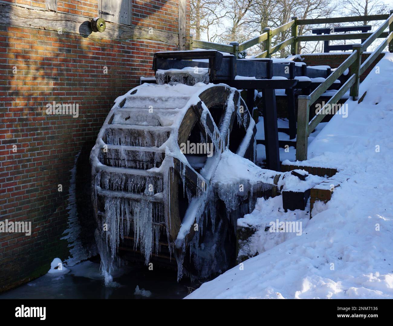 Old restored water mill in Wilsum, Germany after a extreme cold night ...