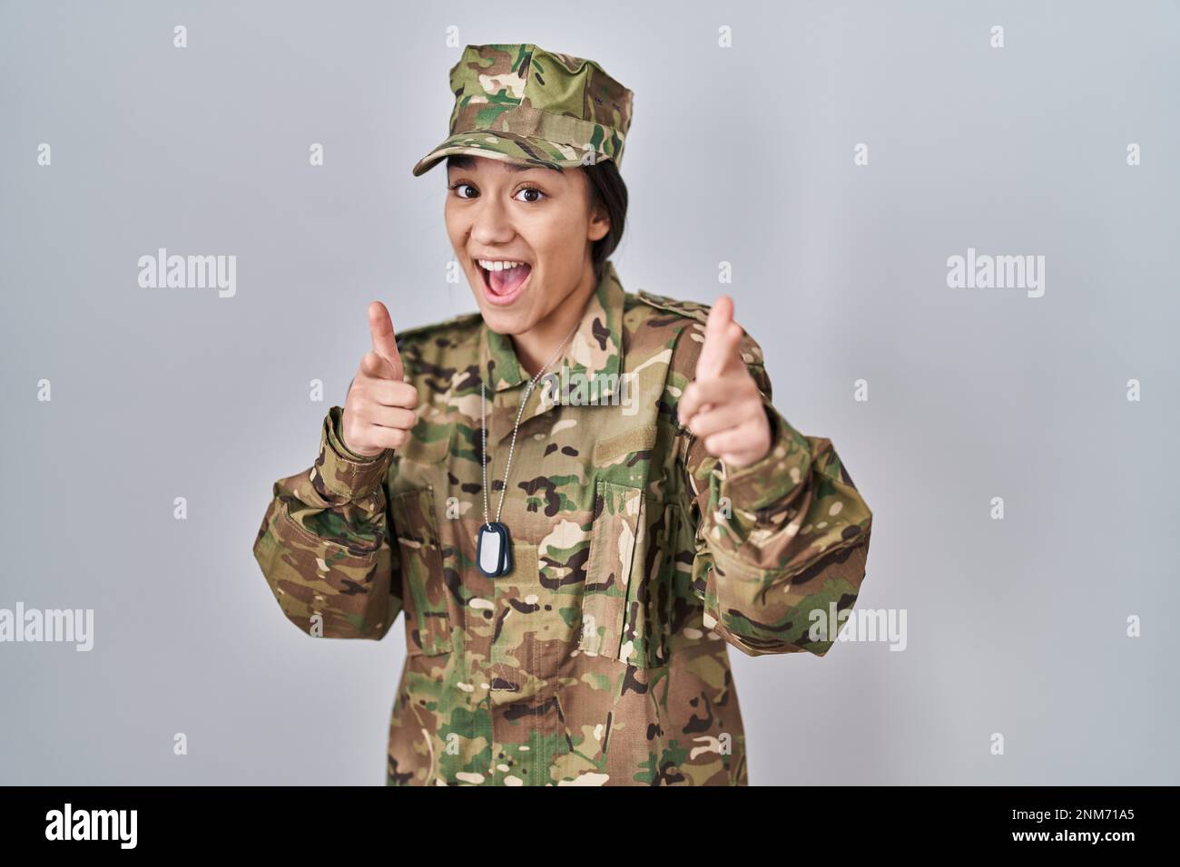 Young south asian woman wearing camouflage army uniform pointing ...