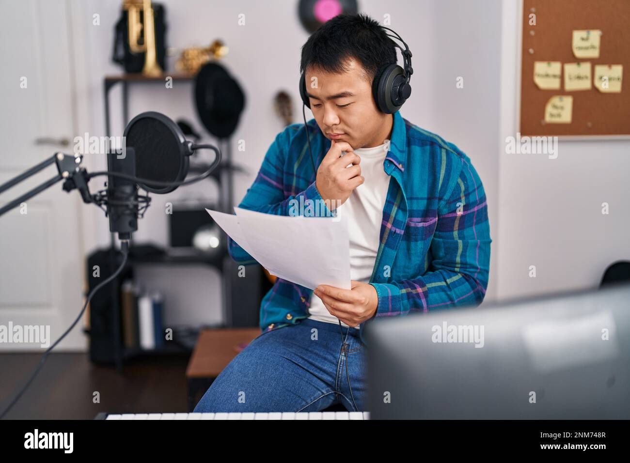 Young chinese man singer singing song at music studio Stock Photo - Alamy