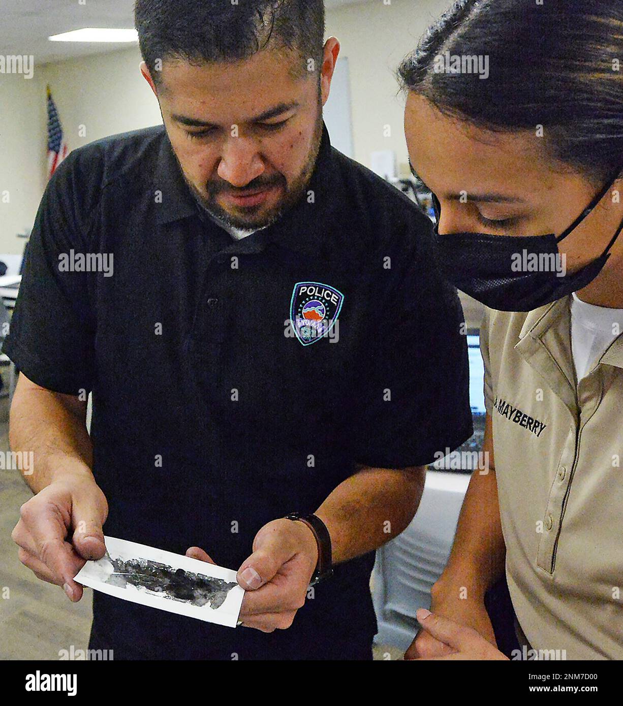 Yuma Police Department Officer Adrian Rodriguez, left, looks over the ...