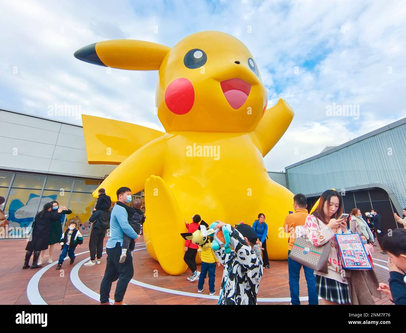 Shoppers gather around a 10-meter-tall Pikachu sculpture, claimed to be ...