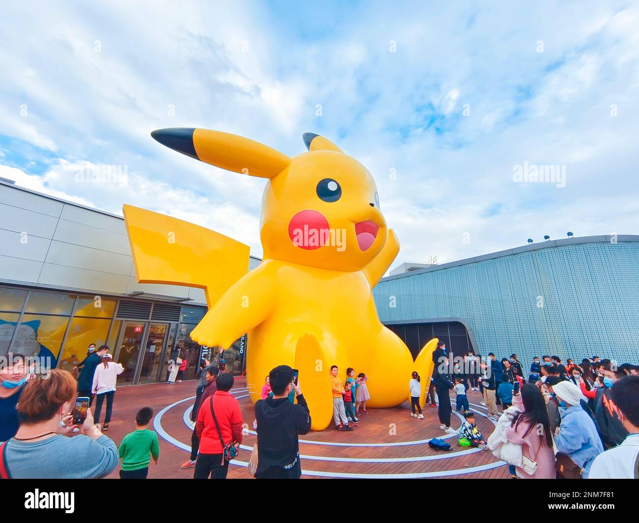 Shoppers gather around a 10-meter-tall Pikachu sculpture, claimed to be ...