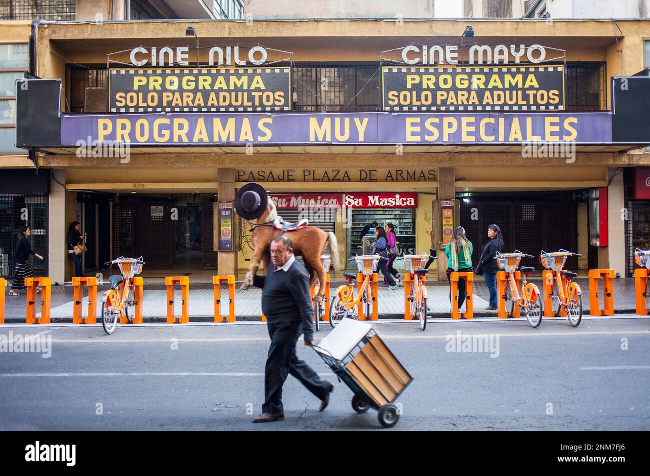 photographer walking to work, street scene in Monjitas street, Santiago ...