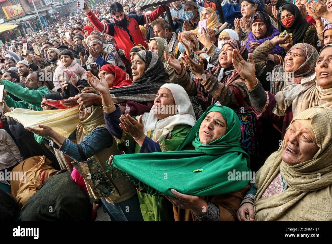 Thousands of Muslim devotees offer prayers as a priest displays a relic ...