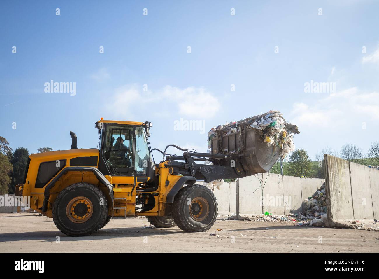 Heavy construction machine, front end loader moving along recycling ...