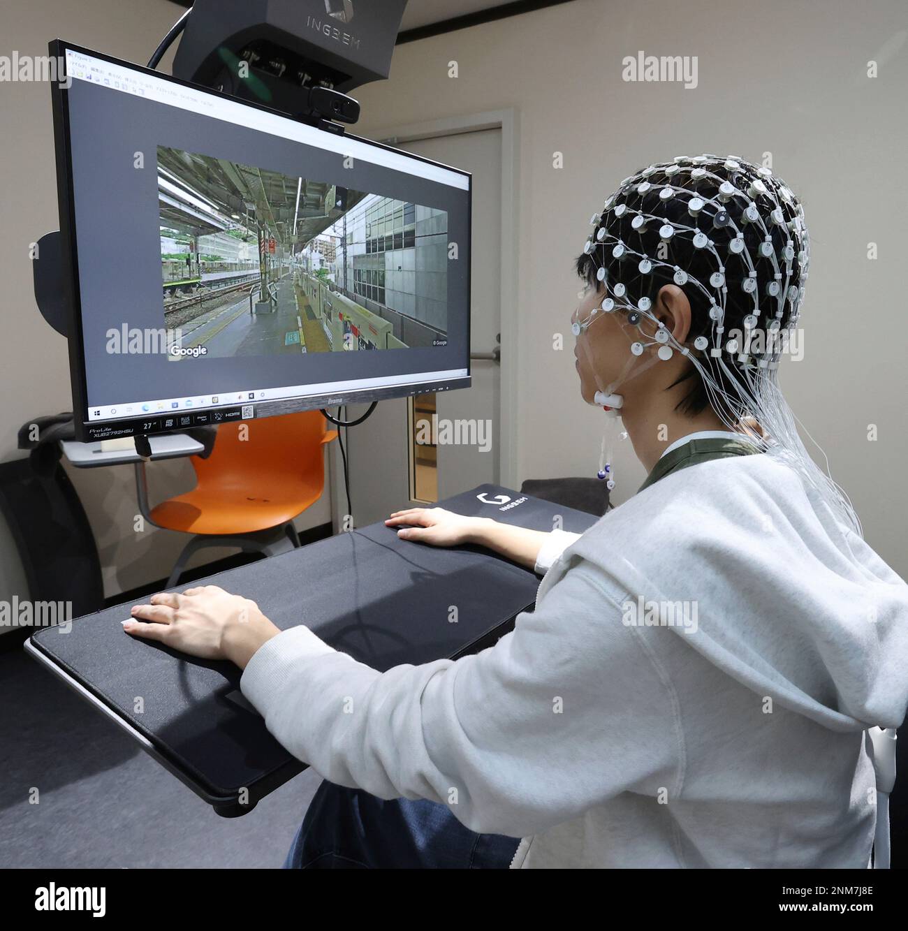 A photo shows the research on brain waves (electroencephalogram) by Keio University Professor ...