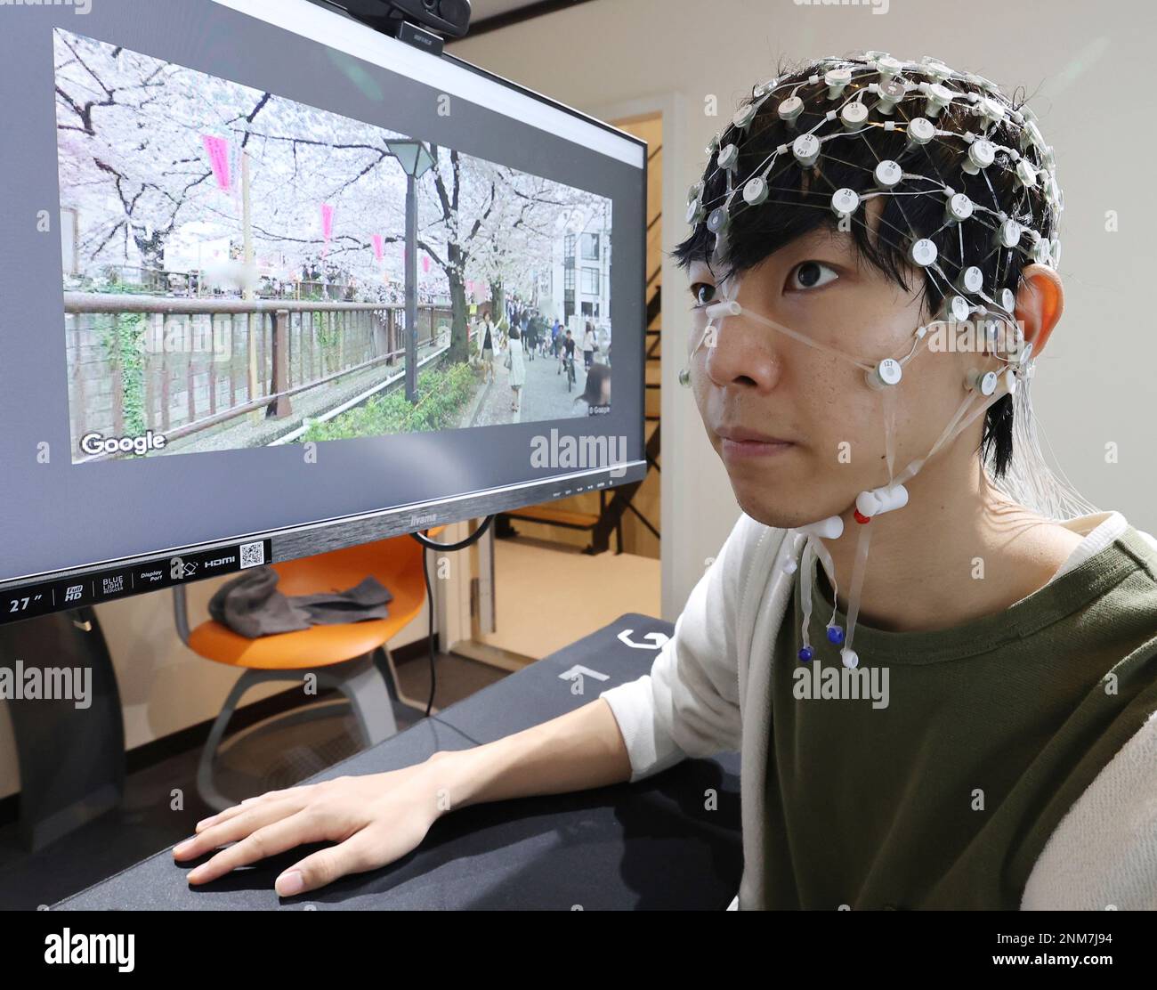 A photo shows the research on brain waves (electroencephalogram) by Keio University Professor ...
