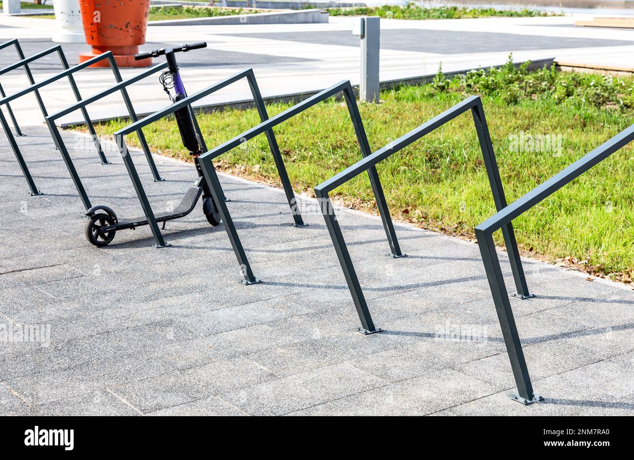 Metal parking lot for bicycles on the city street in summer Stock Photo ...