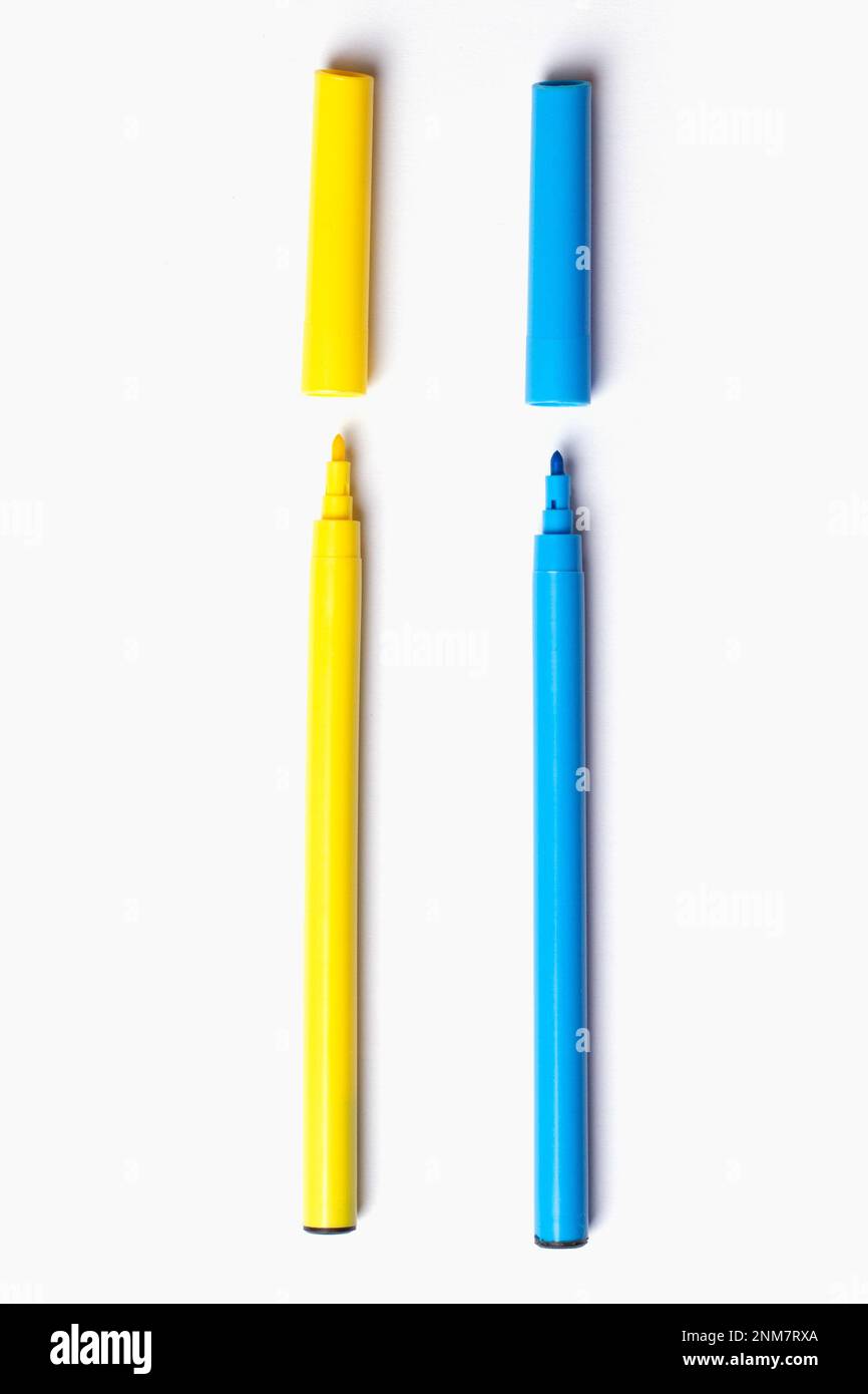 Two markers in a row on a white background Stock Photo - Alamy