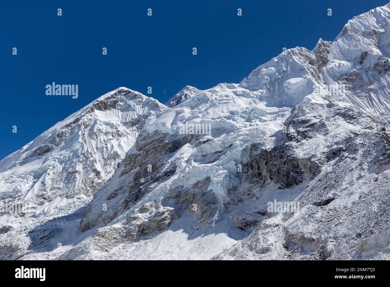 Beautiful snow and ice covered mountains view up to the peaks and blue ...