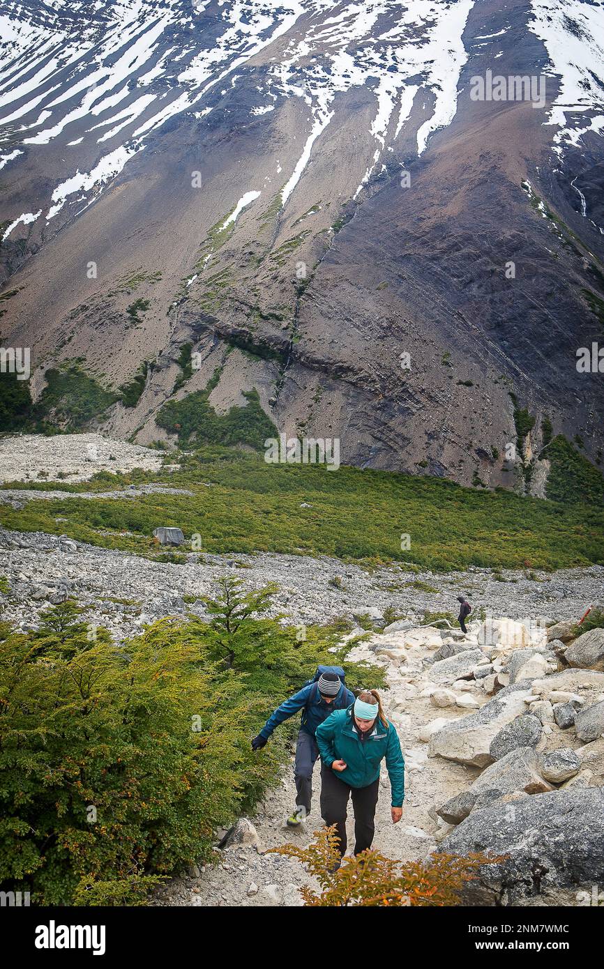Hikers ascending the Moraine of Mirador Base Torres, Torres del Paine ...