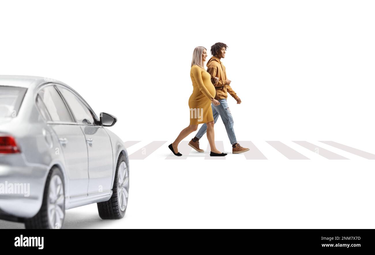 Pregnant woman and a young man walking on a pedestiran crossing and car ...