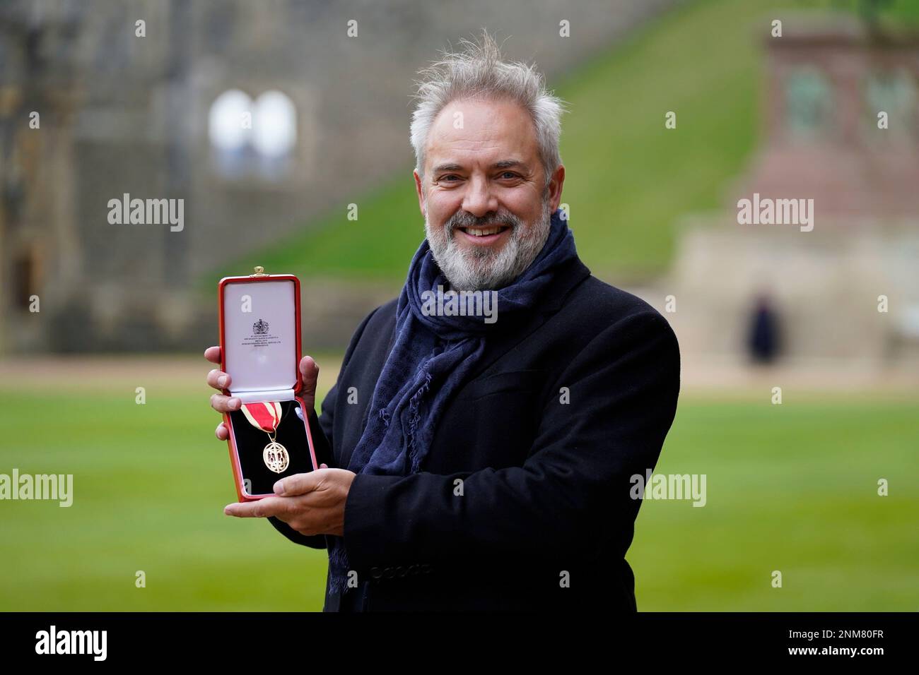 British film director Sam Mendes displays his award after being ...